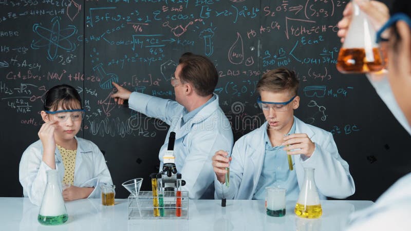 Cute Girl Looking Under Microscope while Student Doing Experiment ...