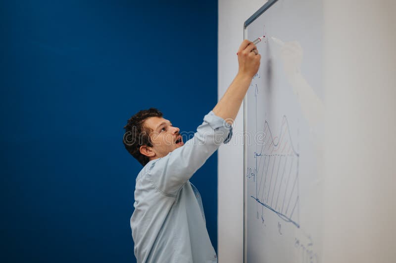 Teacher Explaining Graph on Whiteboard during Classroom Lecture Stock ...