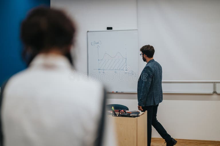 Teacher Explaining Graph on Whiteboard during Classroom Lesson Stock ...