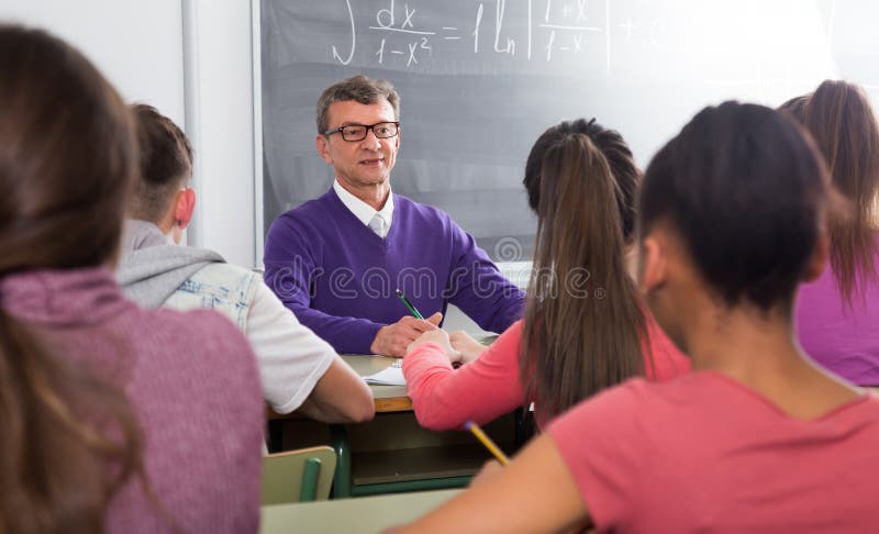Teacher Explaining the Math Near Chalkboard Stock Photo - Image of ...