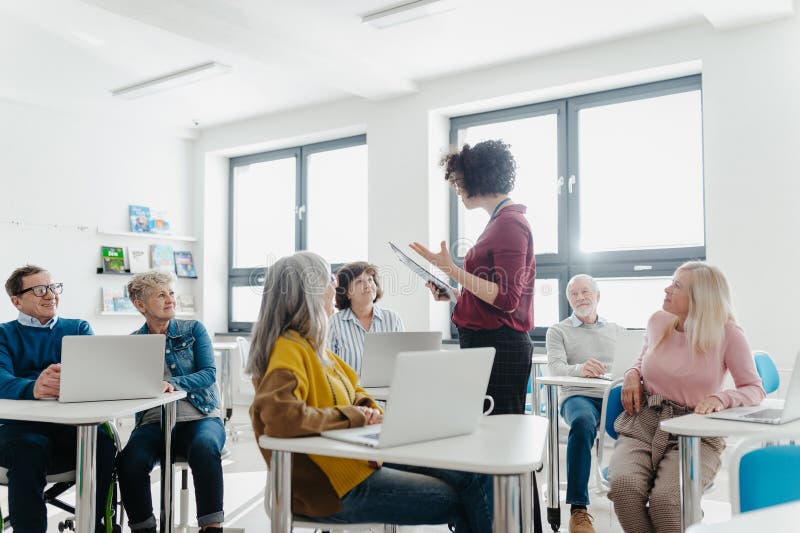 Teacher Explaining Senior Students How To Work with Laptop and Internet ...