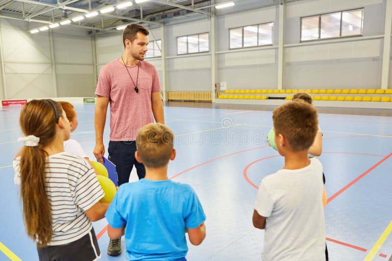 Teacher Explaining Students Standing in Gym Class Stock Image - Image ...