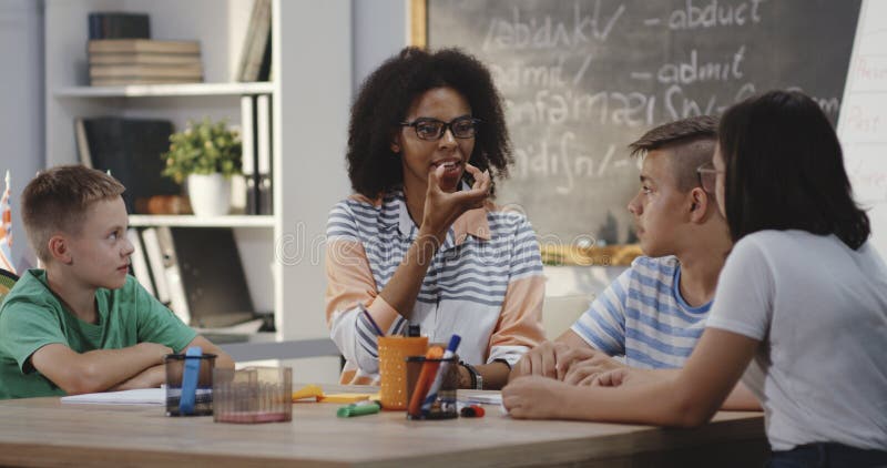 Teacher Explaining To Pupils in a Classroom Stock Photo - Image of ...