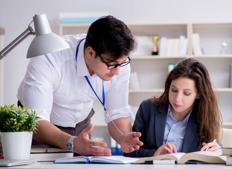 Teacher Explaining To Student at Lecture Stock Image - Image of book ...