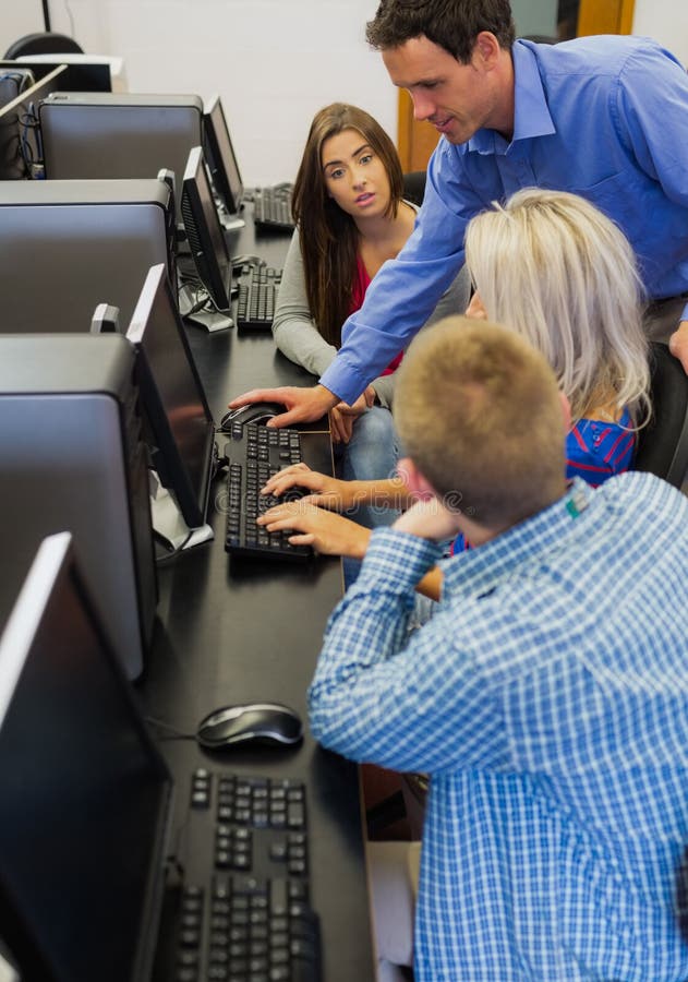 Teacher Explaining To Students in Computer Room Stock Photo - Image of ...