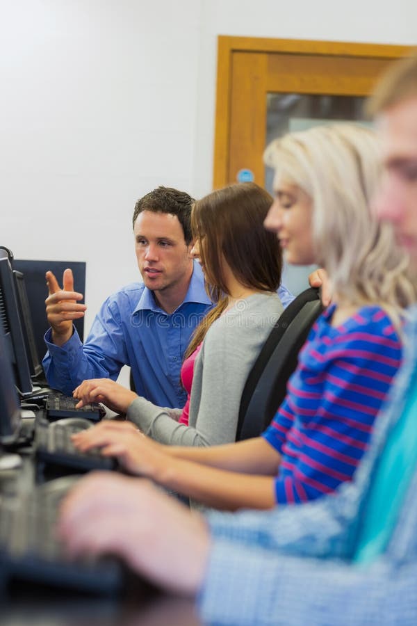 Teacher Explaining To Students in the Computer Room Stock Photo - Image ...
