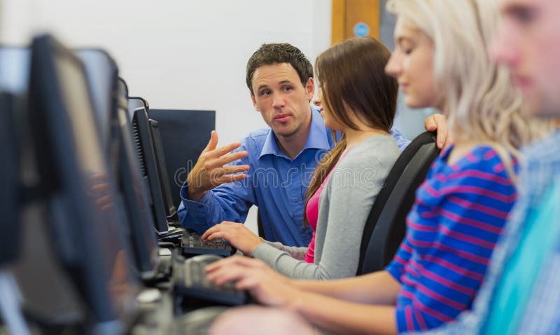 Teacher Explaining To Students in the Computer Room Stock Image - Image ...