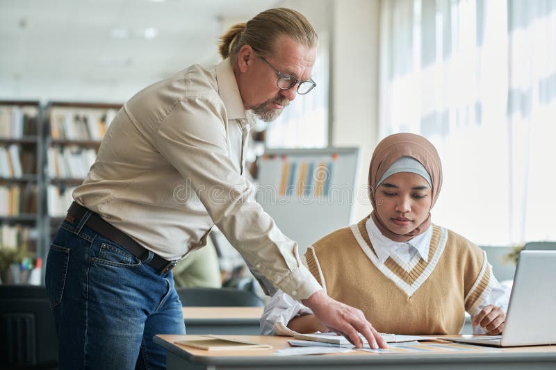 Teacher Explaining Topic To Foreign Student Stock Image - Image of ...