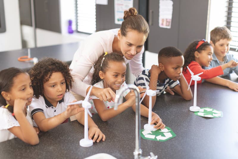Teacher Explaining about Windmill To School Kids at School in Classroom ...