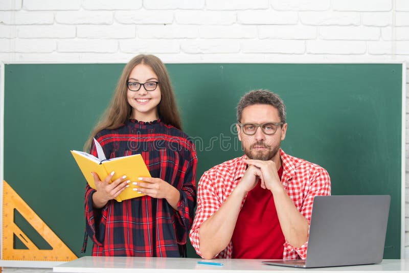 Teacher Explains Lesson To School Child. Elementary School Kids ...