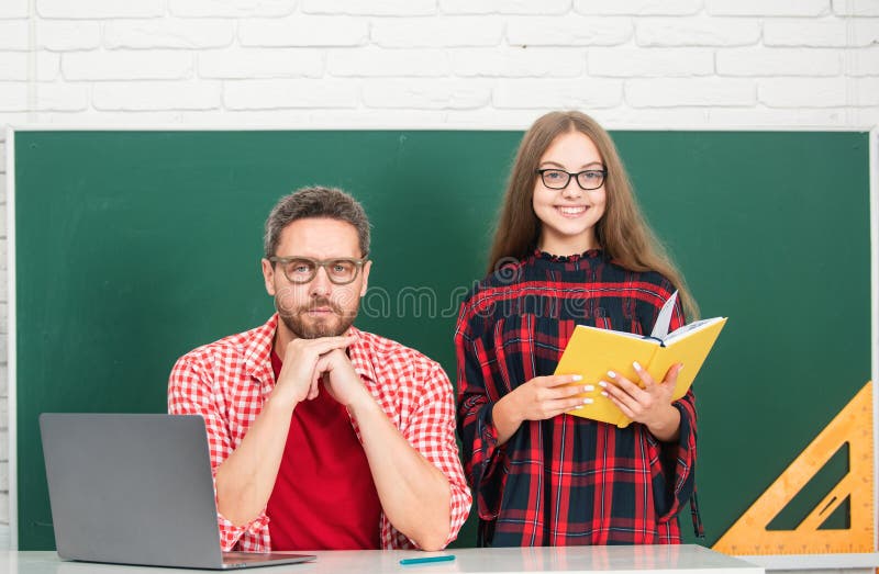 Teacher Explains Lesson To School Child. Elementary School Kids ...