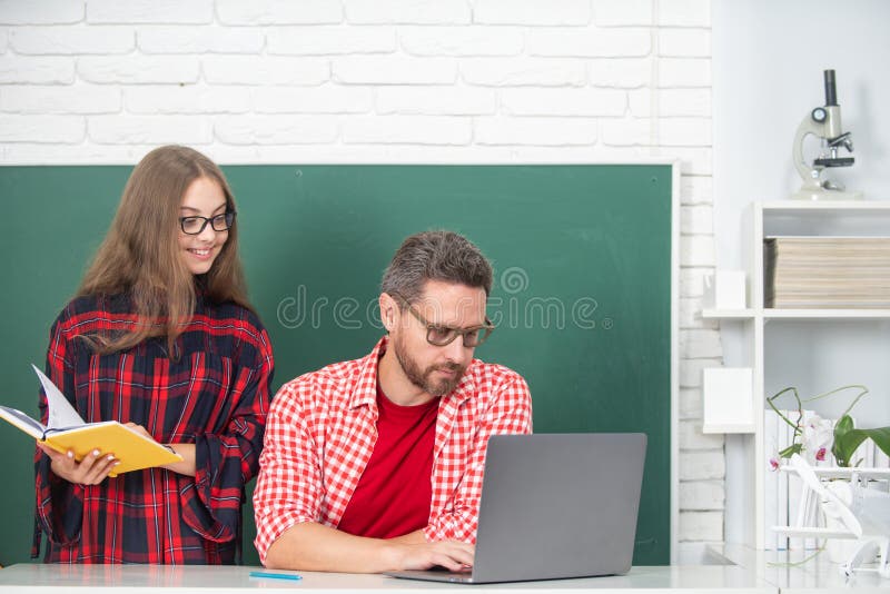 Teacher Explains Lesson To School Child. Elementary School Kids ...