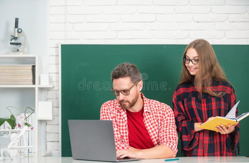 Teacher Explains Lesson To School Child. Elementary School Kids ...