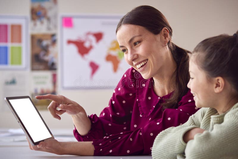 Teacher and Female Student in School Classroom Using Digital Table ...