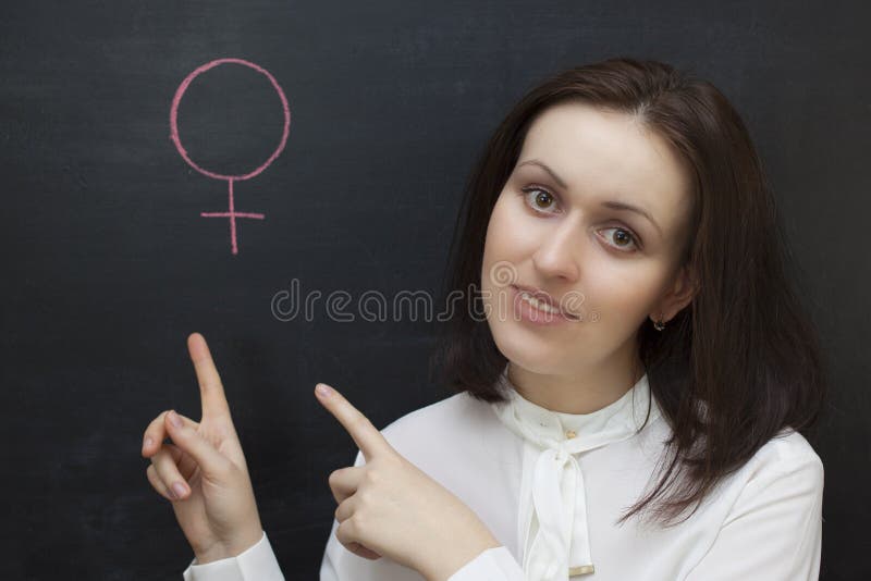 Teacher Girl At The Chalkboard Shows The Gender Symbol Of A Woman Sex
