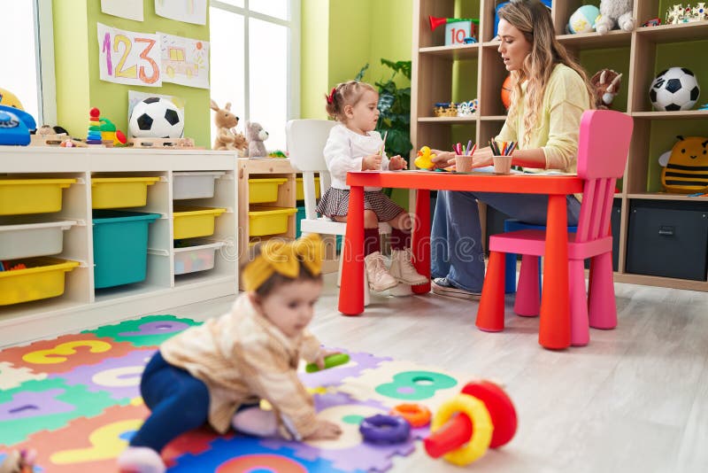 Teacher with Girls Playing at Kindergarten Stock Image - Image of ...