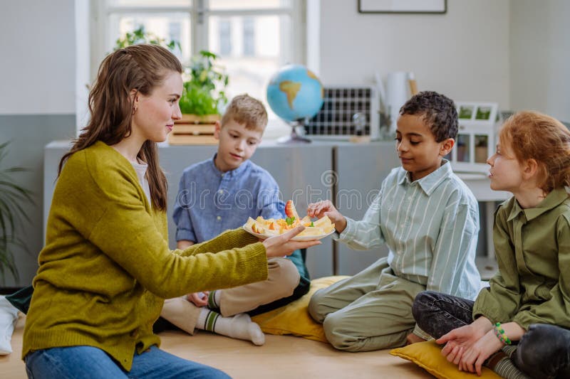 Teacher Giving Healthy Fruit Snack for Pupils. Stock Image - Image of ...