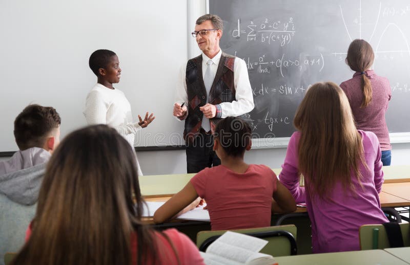 Man giving a math lesson stock image. Image of class - 179672113