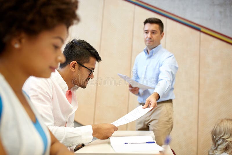 Teacher Giving Tests To Students at Lecture Stock Photo - Image of ...