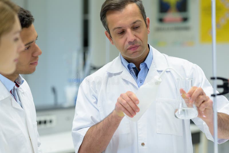 Teacher with Graduate Students in Lab Stock Image - Image of chemistry ...