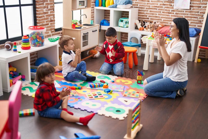 Teacher with Group of Boys Playing with Maths Puzzle Game Sitting on ...