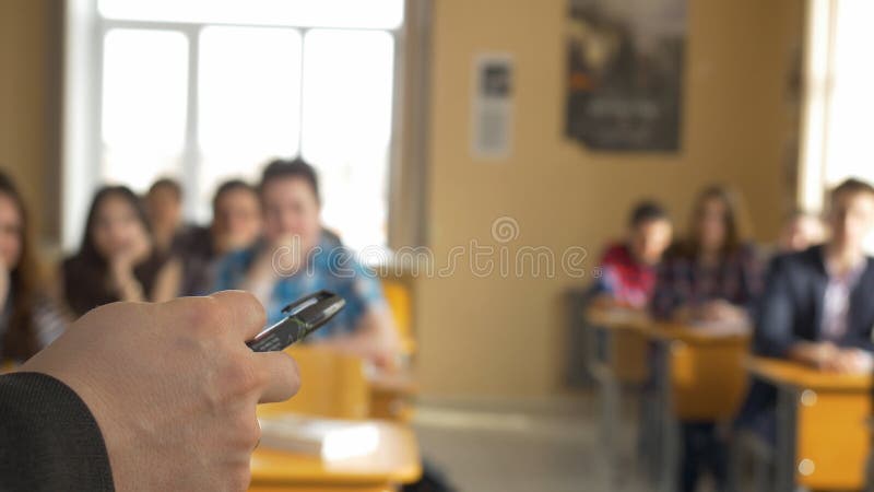 Teacher with a Group of High School Students in Classroom. View from ...