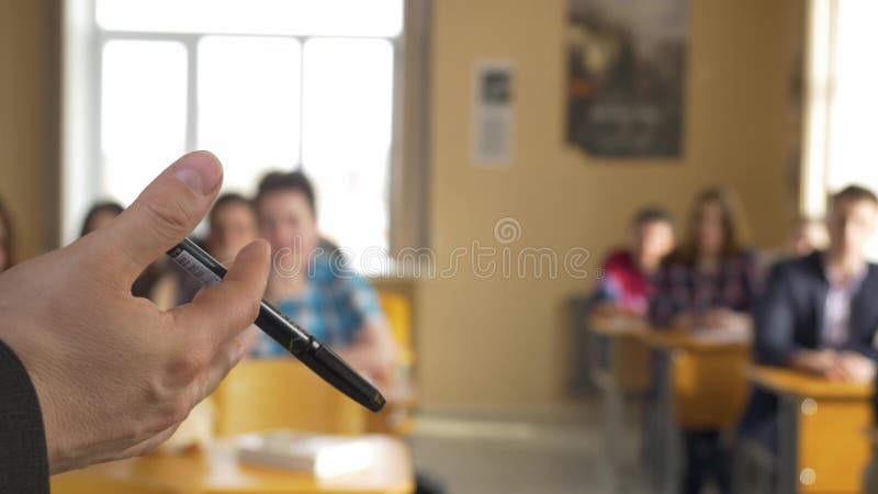 Teacher with a Group of High School Students in Classroom. View from ...