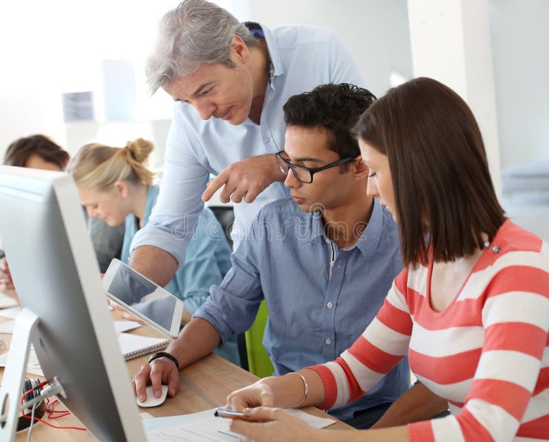 Teacher with Group of Students in Classroom Stock Image - Image of ...