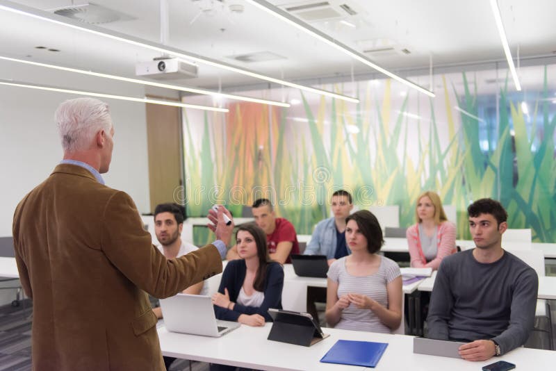 Teacher with a Group of Students in Classroom Stock Image - Image of ...