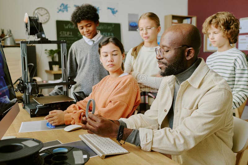 Teacher Guiding Middle School Students in Classroom Activity Stock ...