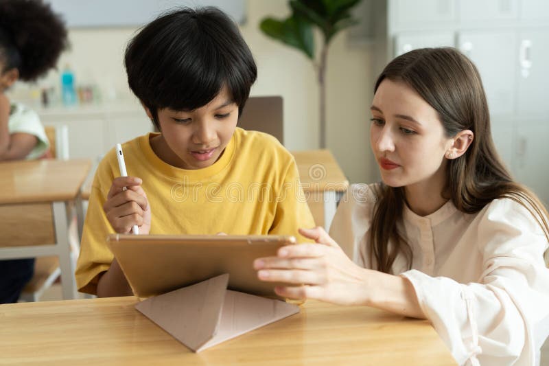 Teacher Guiding Student with Digital Learning in Diverse Classroom ...