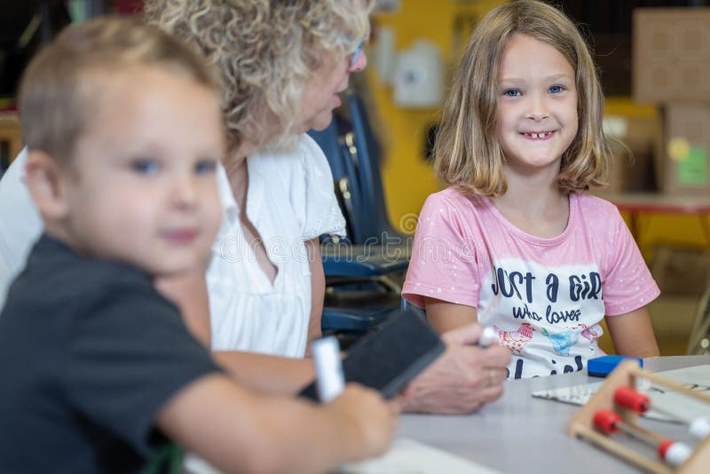 A Teacher is Helping a Child with a Math Problem Stock Photo - Image of ...