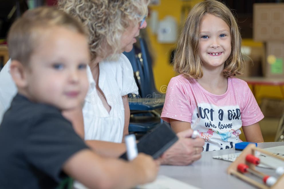A Teacher is Helping a Child with a Math Problem Stock Photo - Image of ...