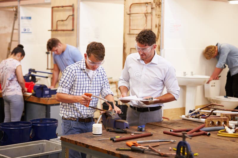 Teacher Helping College Students Studying Plumbing Stock Photo - Image ...