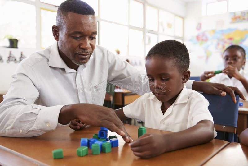 Teacher Helping Elementary School Boy Counting with Blocks Stock Image ...