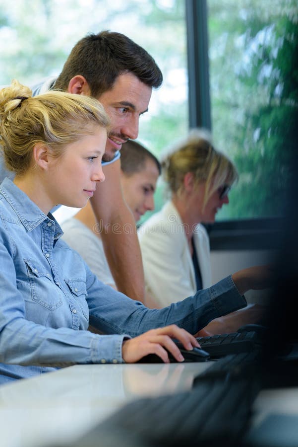 Teacher Helping Female Student in Computer Class Stock Image - Image of ... Teacher Helping Female Student in Computer Class Stock Image - Image of ...