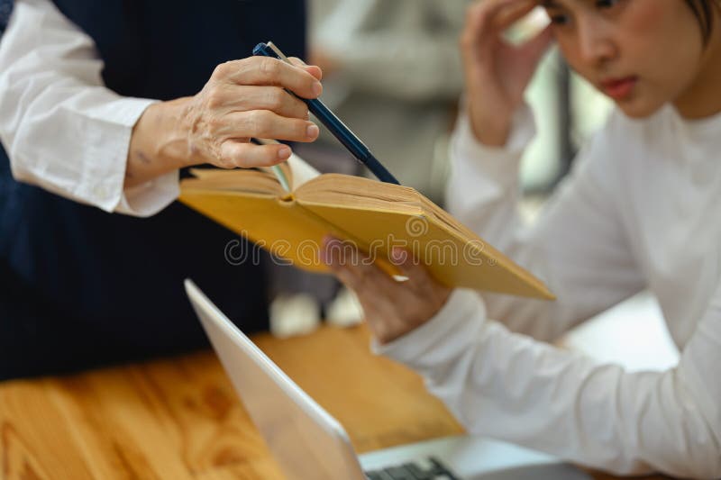 Teacher Helping Female Student Struggling with Schoolwork in a ...