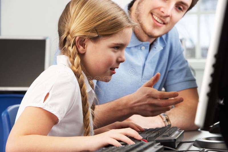 Teacher Helping Girl Using Computer in Class Stock Photo - Image of ...