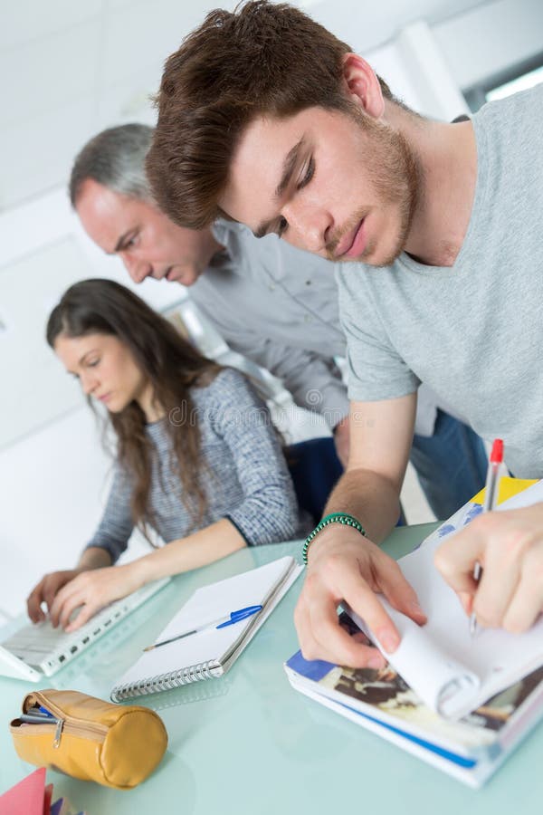 Teacher Helping His Students Stock Photo - Image of college, smile ...