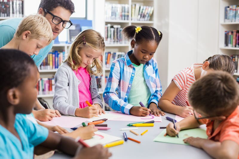 Teacher Helping Kids with Their Homework in Library Stock Photo - Image ...