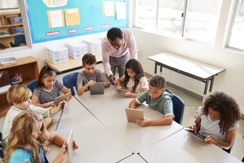 Teacher Helping Kids Using Tablets in Lesson, Elevated View Stock Photo ...