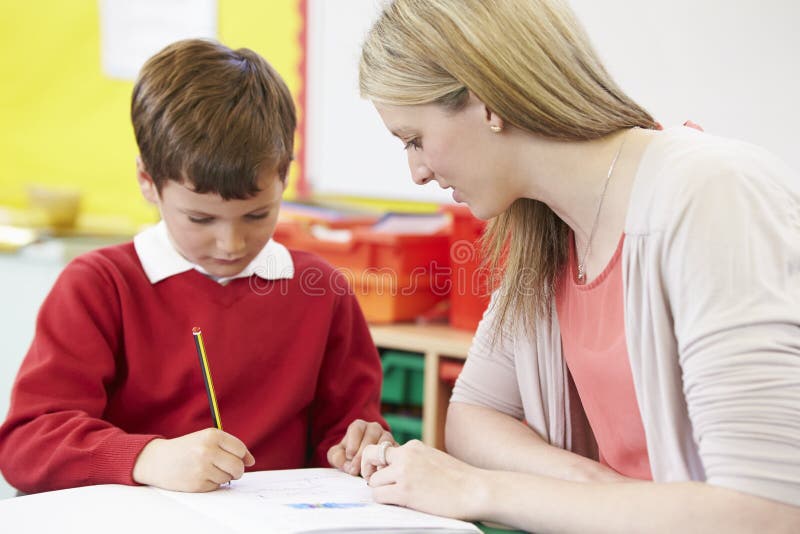 Teacher Helping Male Pupil Practising Writing Desk Stock Photos - Free ... Teacher Helping Male Pupil Practising Writing Desk Stock Photos - Free ...