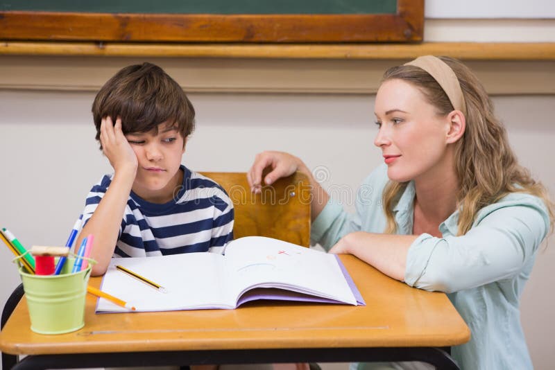 Teacher helping pupil stock photo. Image of schoolchild - 51704330