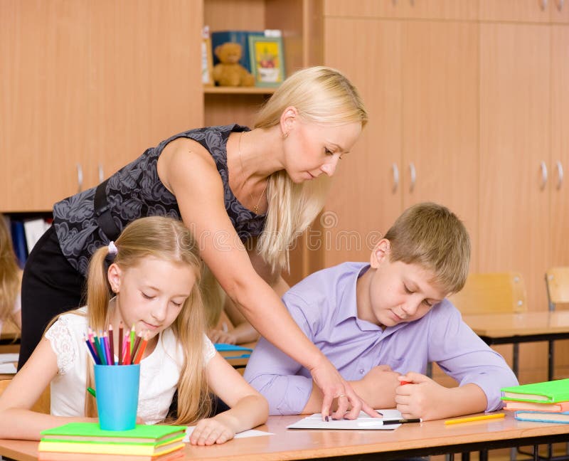 Teacher Helping Pupil Explains How To Solve the Task Stock Image ...