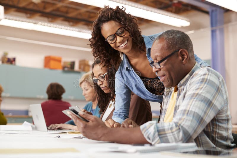 Teacher Helping Retired Senior Man Attending Class Community Centre ...