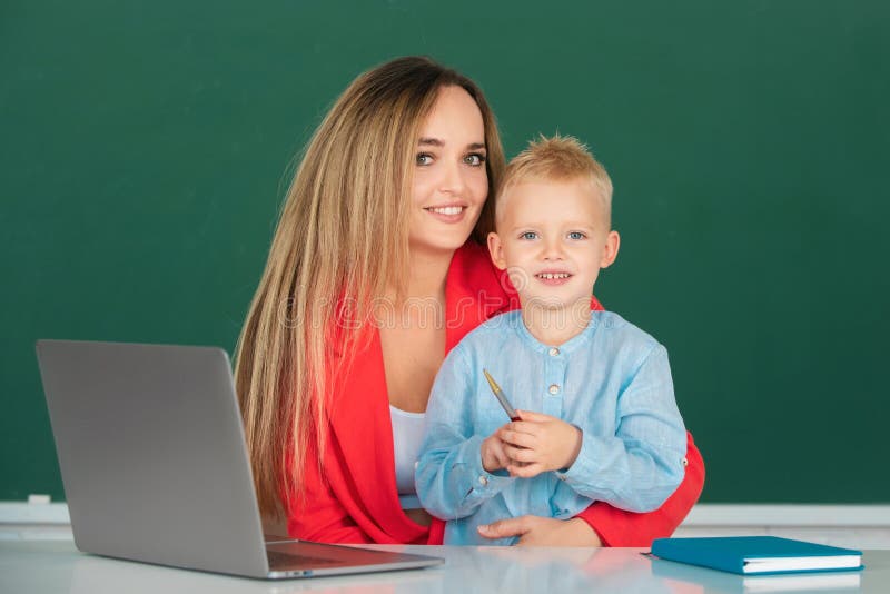 Teacher Helping School Child in Class at School. Mother and Son ...