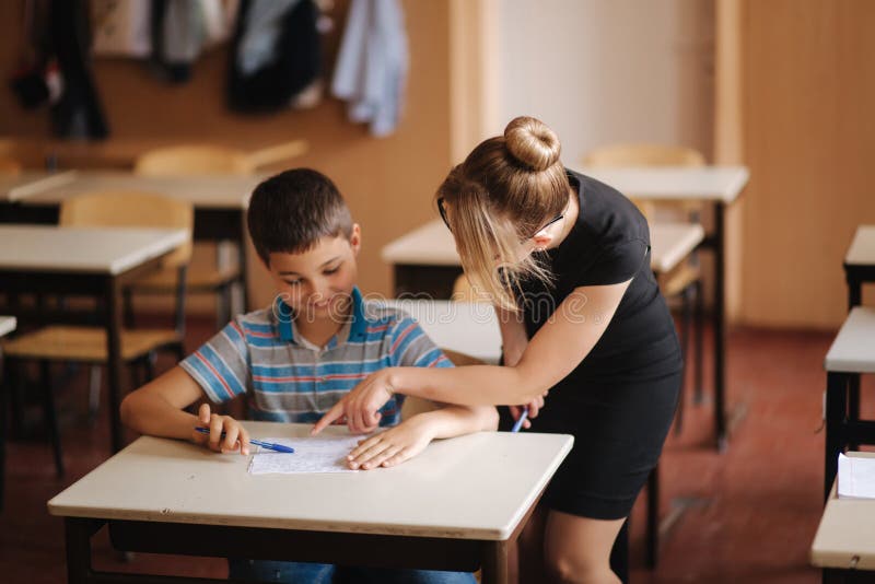 Teacher Helping School Kids Writing Test in Classroom. Education ...
