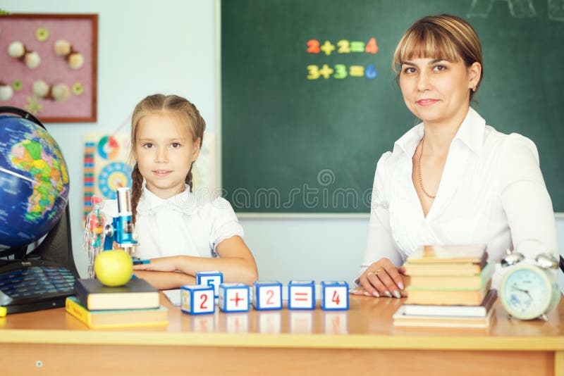 Cute Schoolgirl and Her Teacher in a Classroom Stock Photo - Image of ...