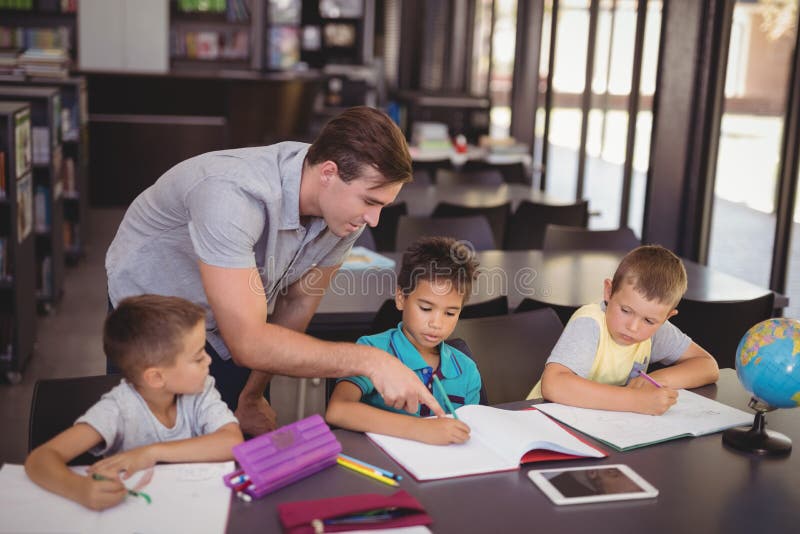 Attentive Schoolkids Doing Their Homework in Library Stock Photo ...