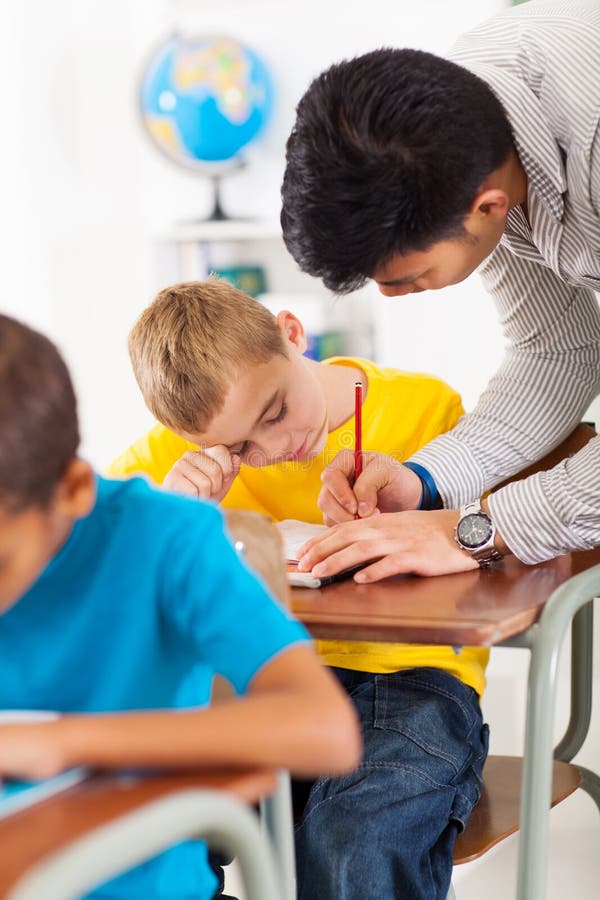 Teacher helping students stock image. Image of learners - 31577413